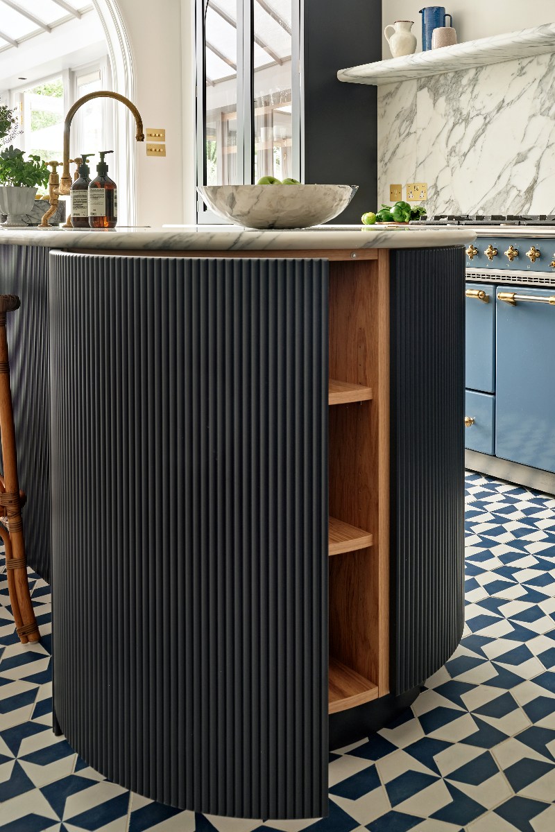 Dark blue kitchen design with marble surfaces and a curved island