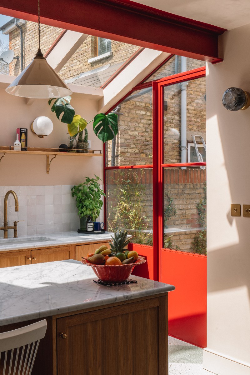 Tour this colourful open-plan kitchen with exposed steel work