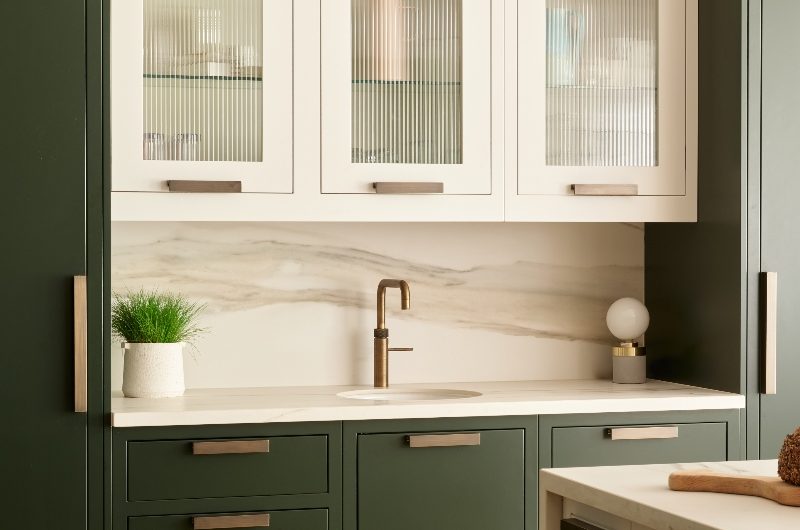 Tour a dark green kitchen with in-frame and fluted glass cabinets